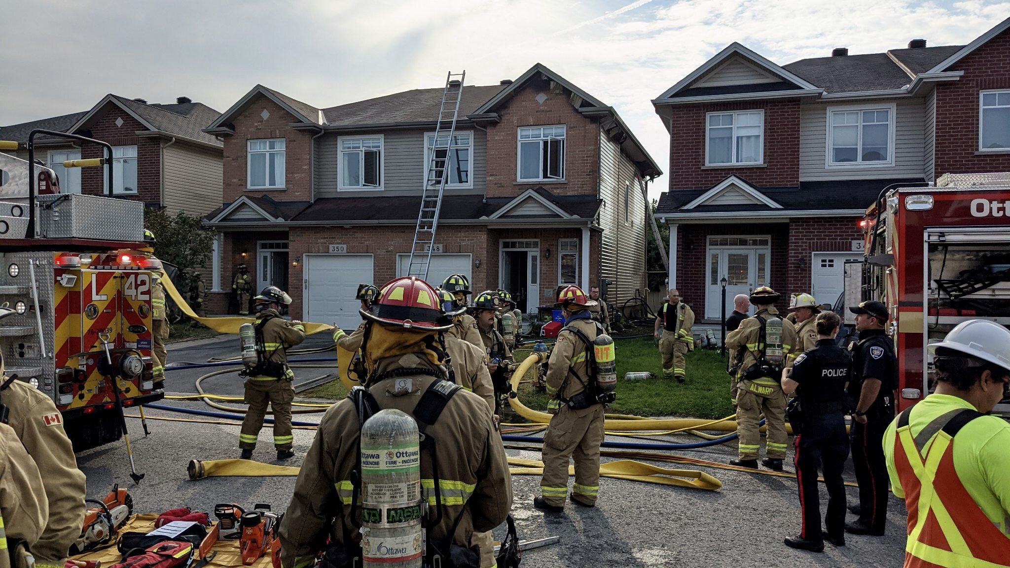 Fire crews bring dog to safety as flames breach townhouse attic